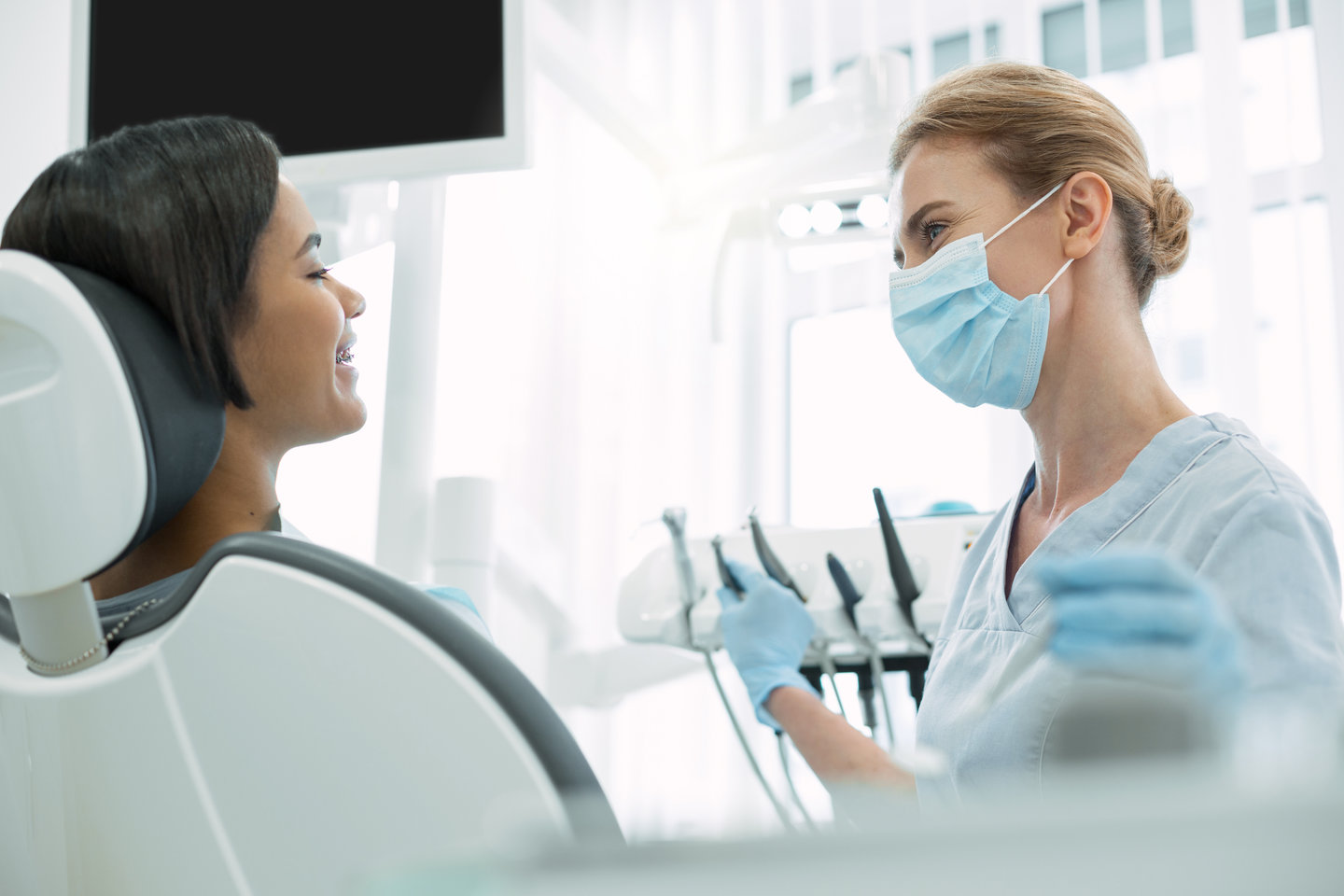 Adorable dentist looking at her patient - Olberding Dental Blog